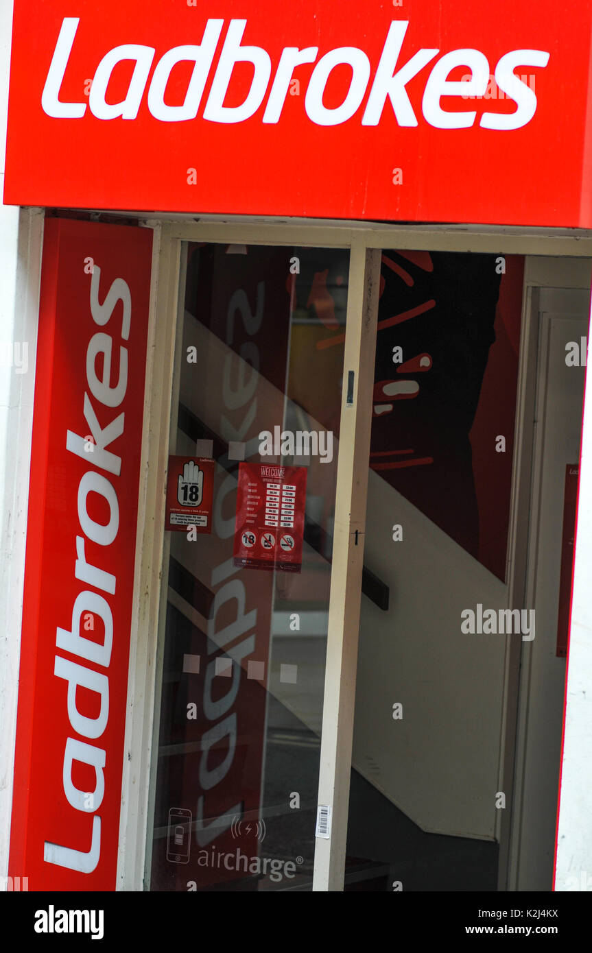 Ladbrokes betting shop sign England UK Stock Photo - Alamy