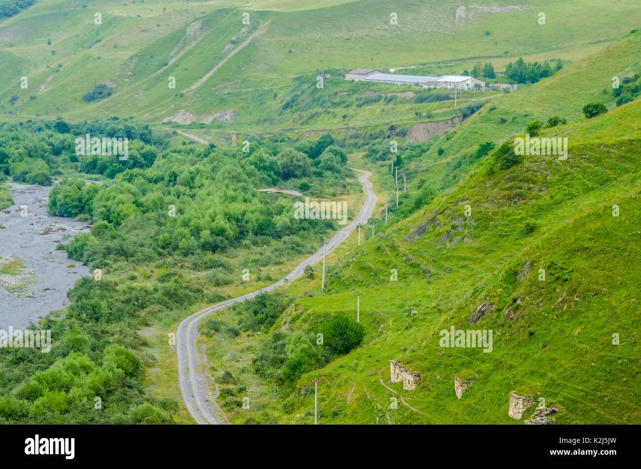 Mountain landscape with river and road Stock Photo - Alamy