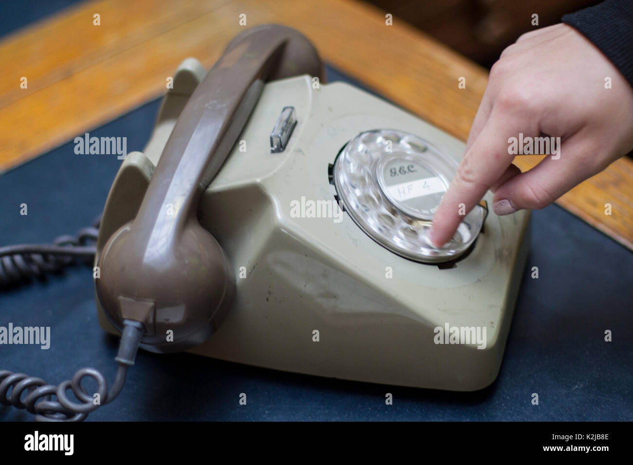 Old-fashioned dial telephone / phone with curly flex and large handle ...