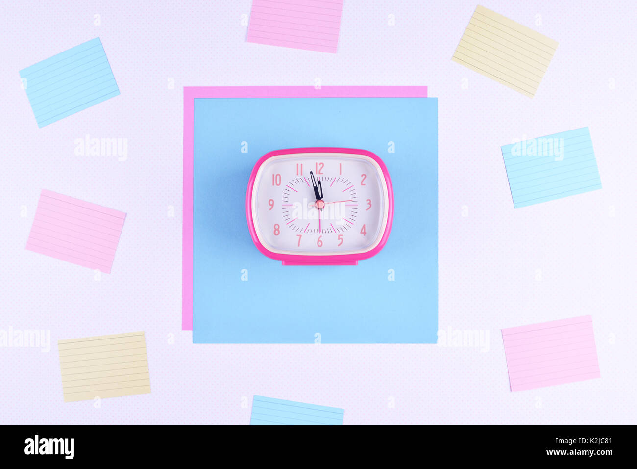 Pink clock on colorful background. Concept of Time. Flat lay style with ...