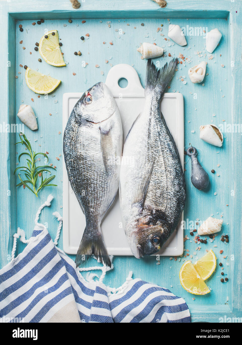 Fresh Sea bream or dorado raw uncooked fish with seasoning on white ...