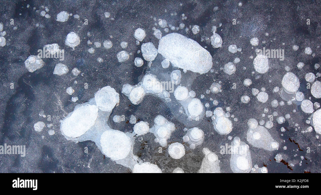 background ice beautiful after a heavy frost. frozen in ice cavity with ...