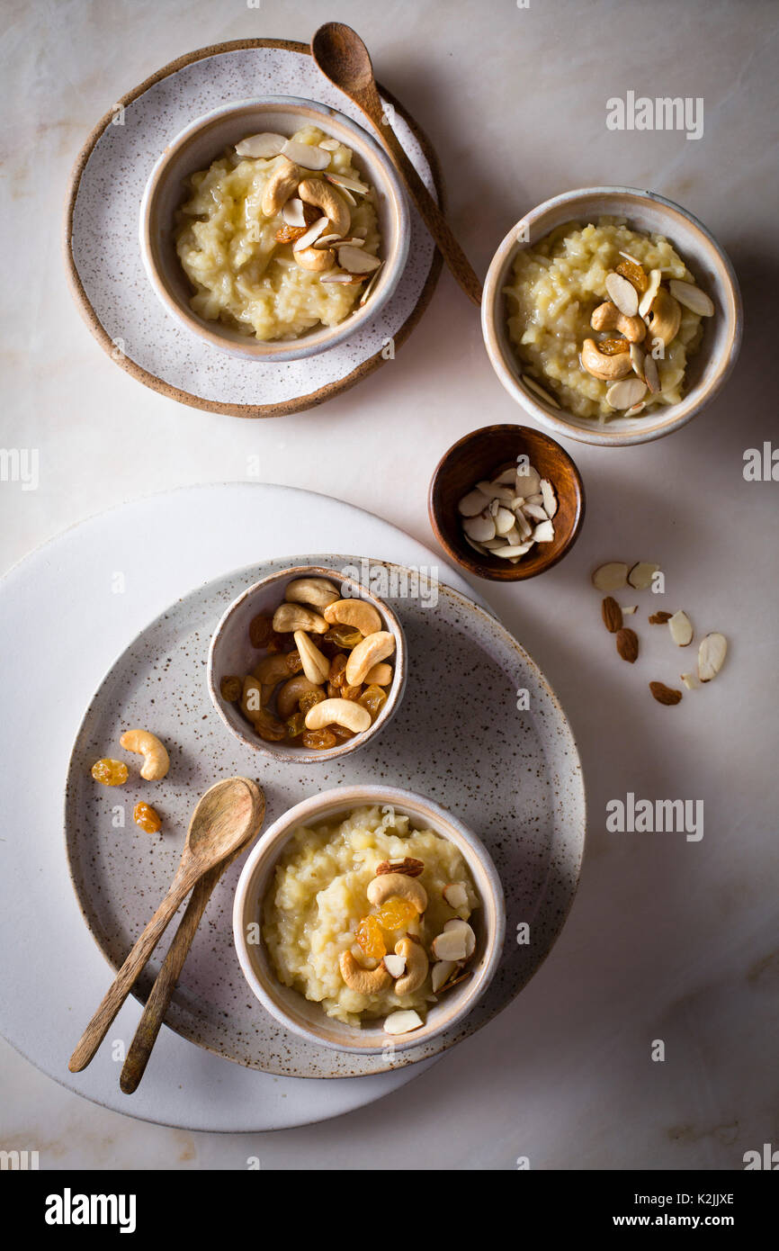 Sweet pongal / rice lentil pudding topped with roasted nuts in ...