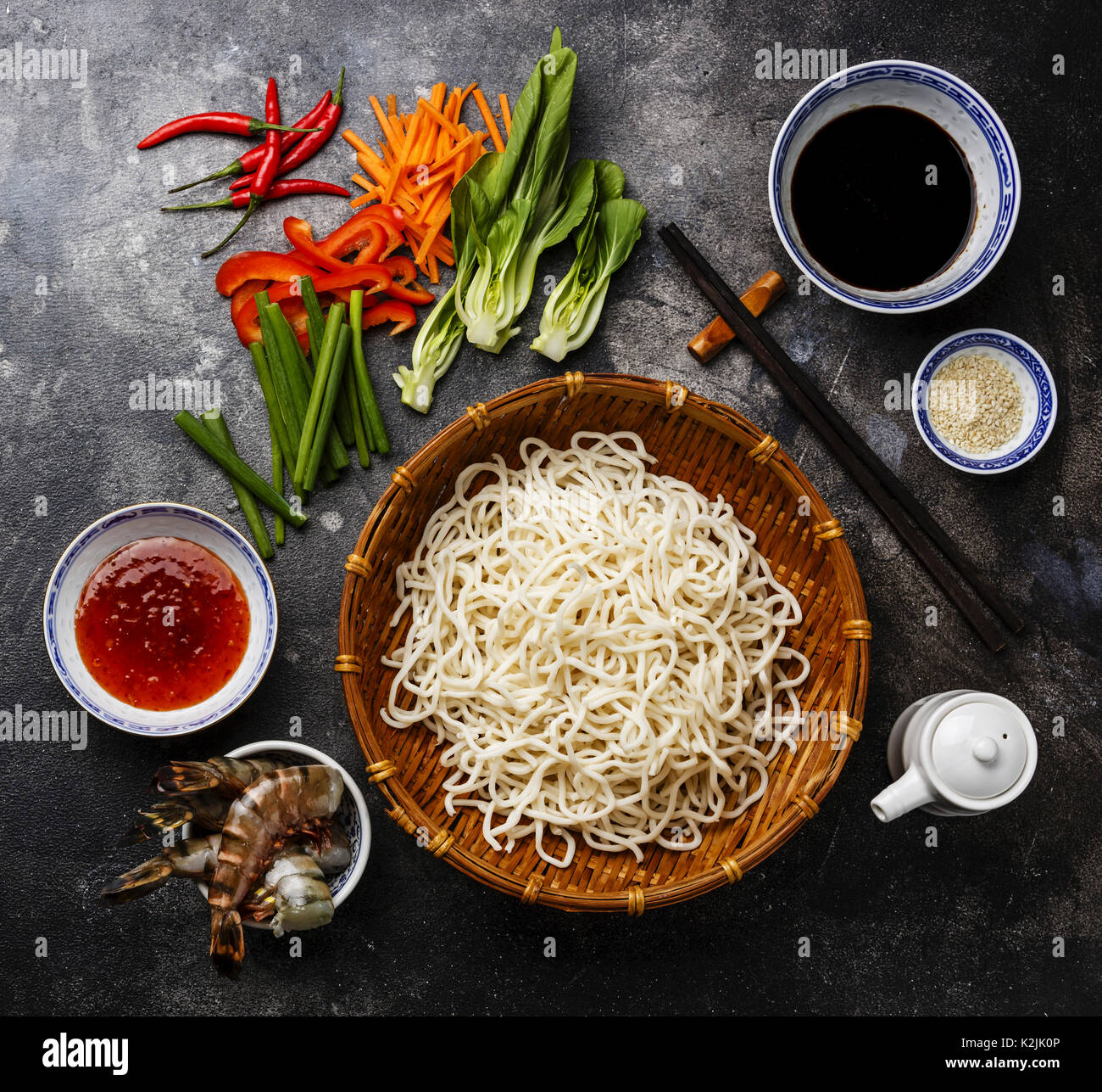 Raw Udon noodles in bamboo basket and Ingredients for cooking asian ...