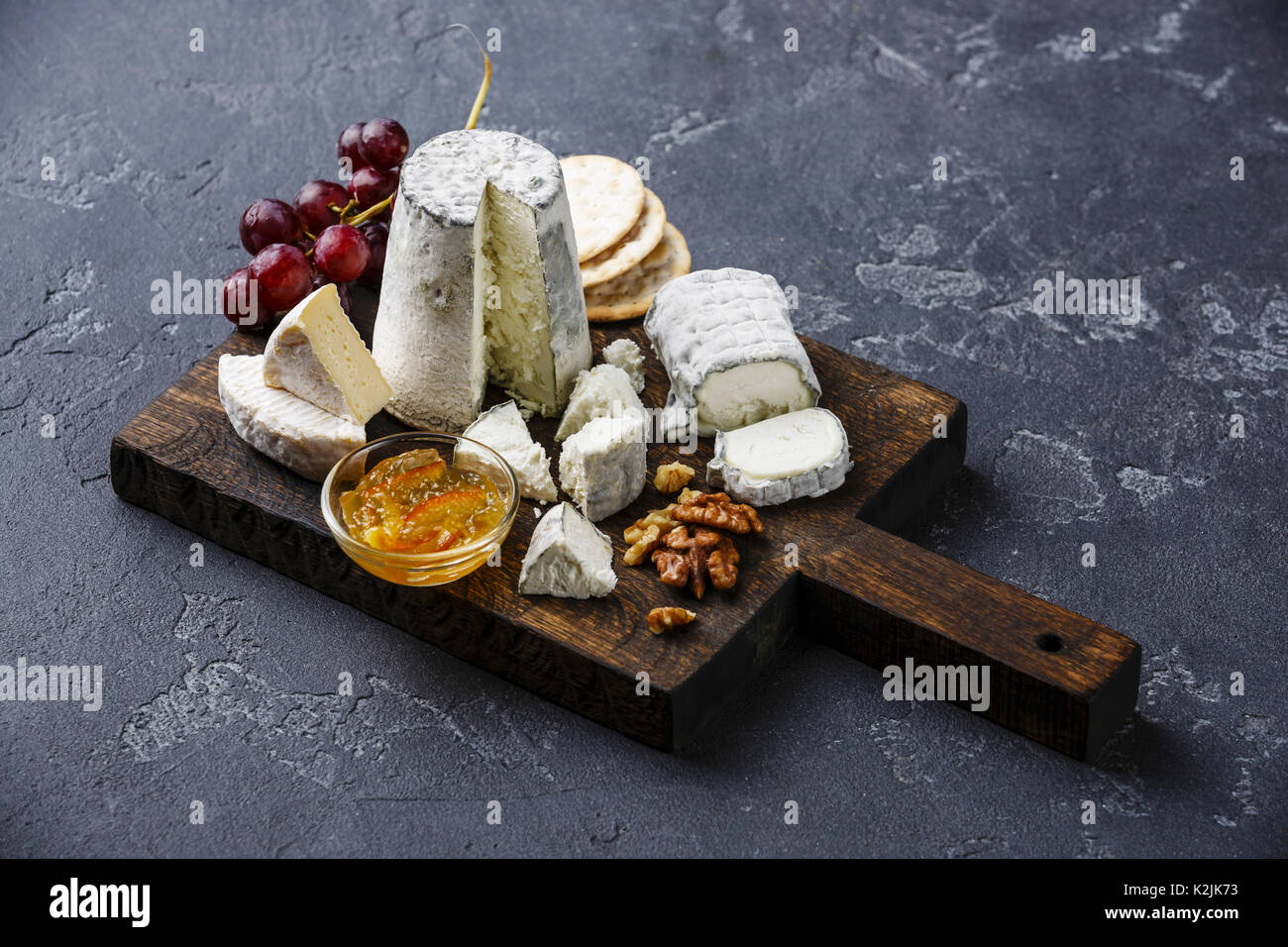 Goat Cheese board Snack assortment with confiture and grape on cutting ...