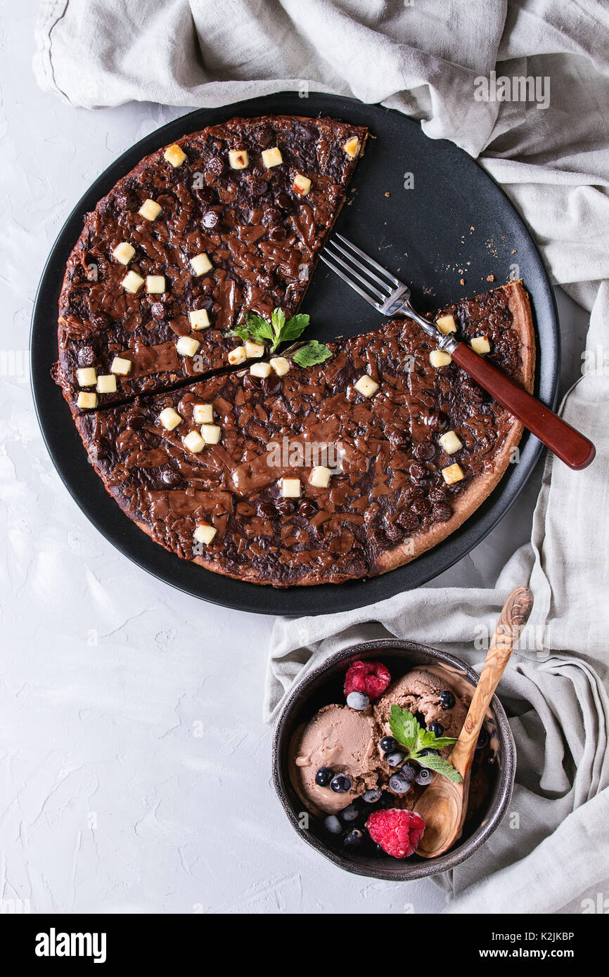 Dessert chocolate pizza with dark, milk, white chocolate, served on ...