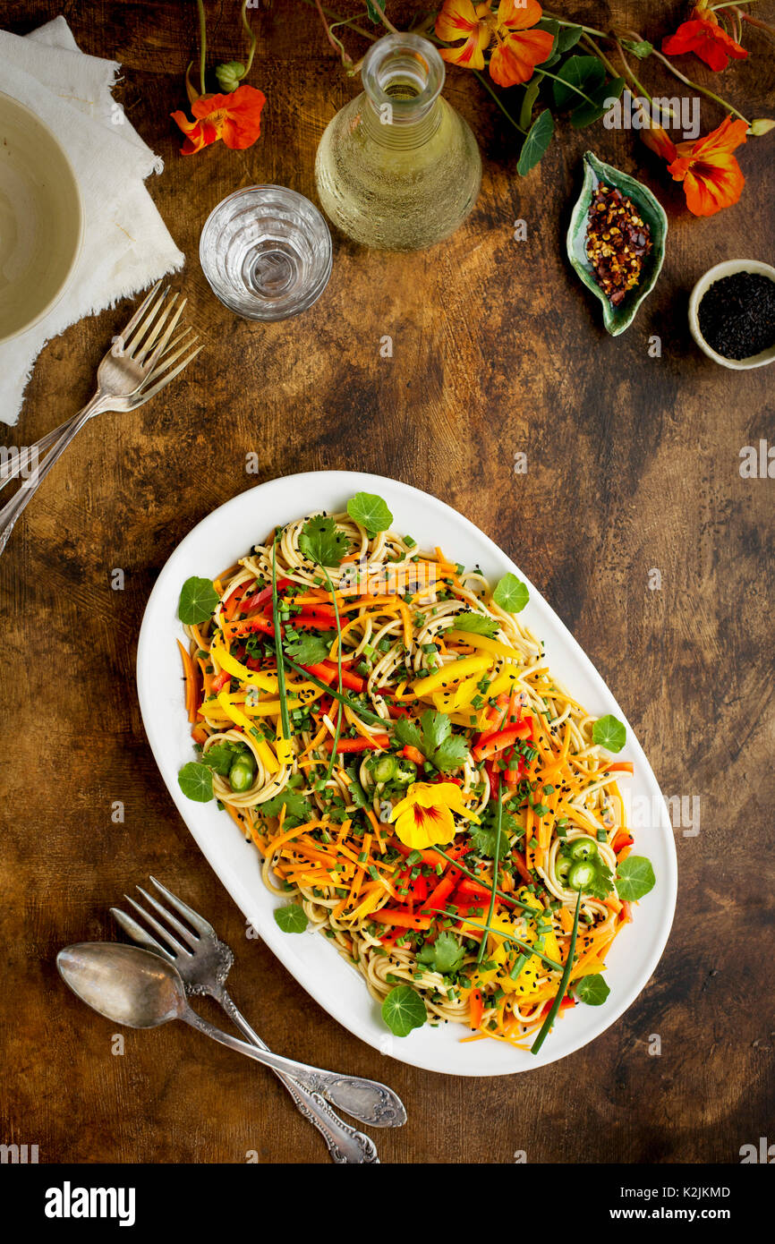 Asian Sesame Pasta Salad served with white wine. Photographed on a ...