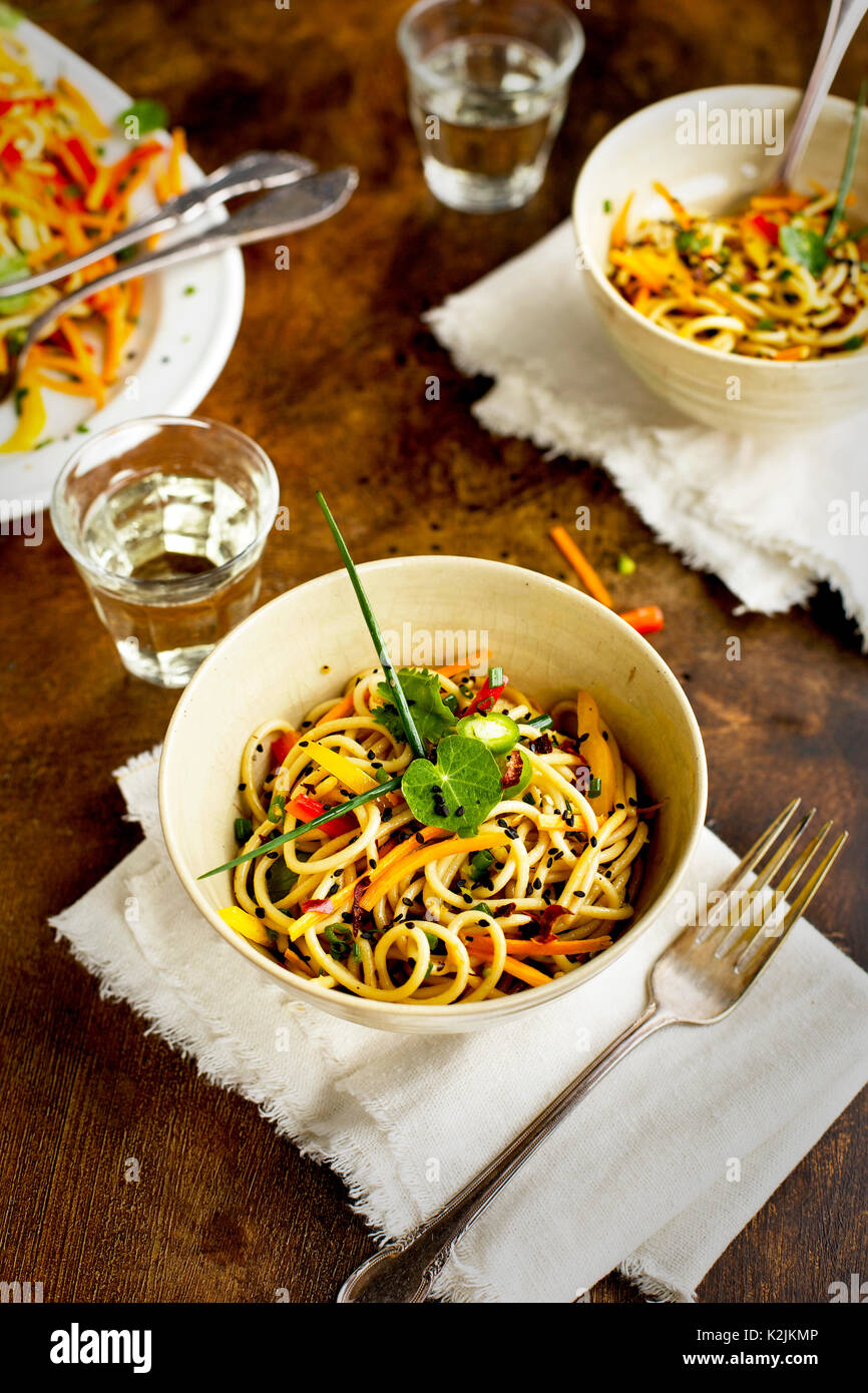 Asian Sesame Pasta Salad served with white wine. Photographed on a ...