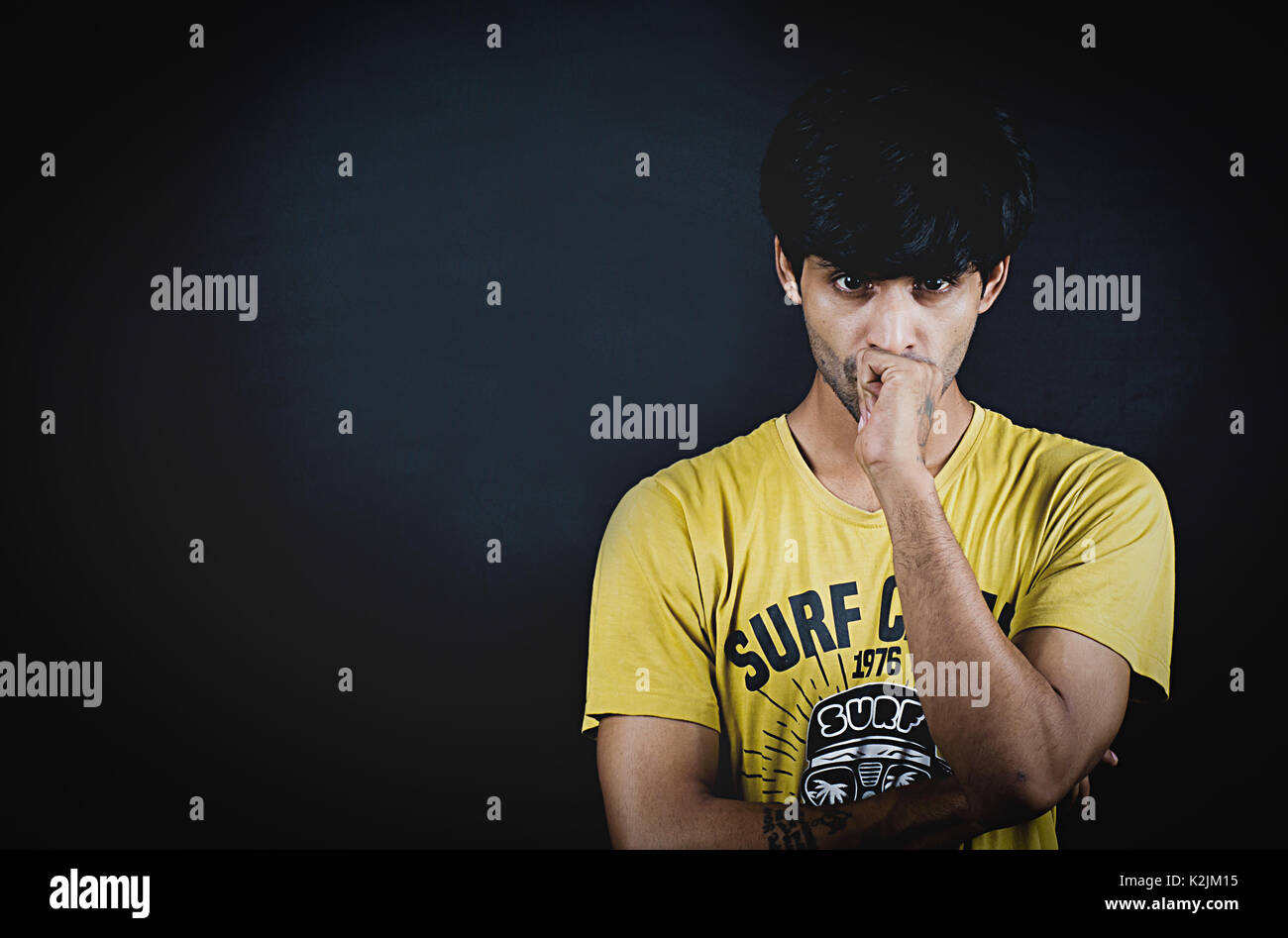 Smart Asian young boy looking tensed in a studio concept shoot with ...