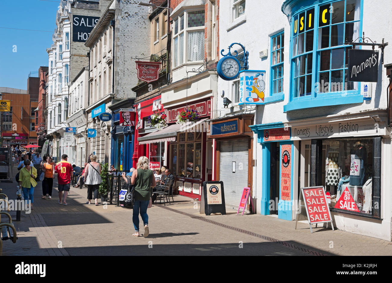 People shopping visitors tourists and stores shops in the town centre ...