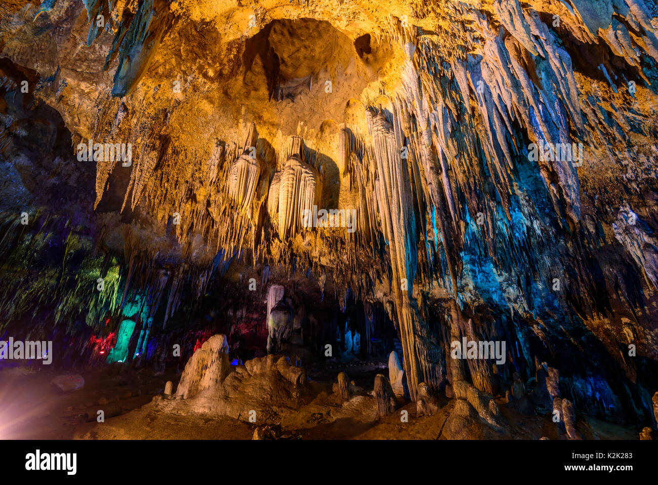 Stalactite stalactites with color lighting in cave Stock Photo - Alamy