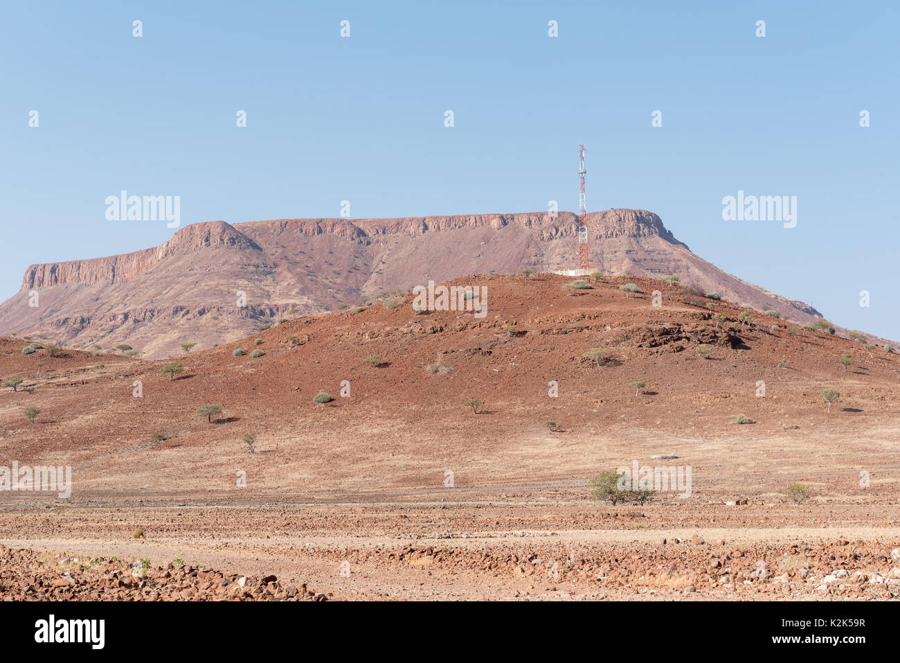 A cellphone tower on a hill in the arid semi-desert landscape at ...