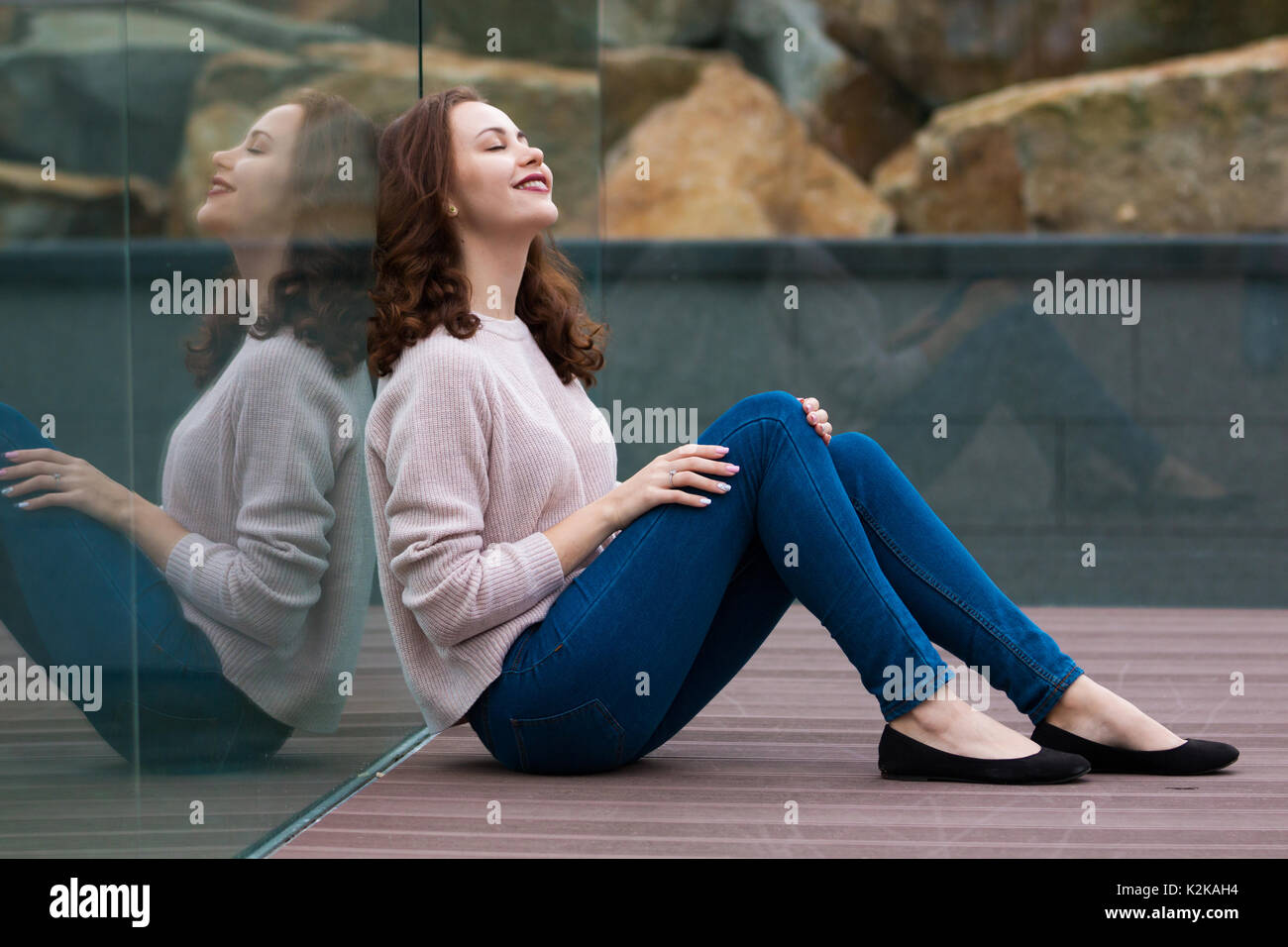 Reflection of cute fashionable girl in modern glass building Stock ...