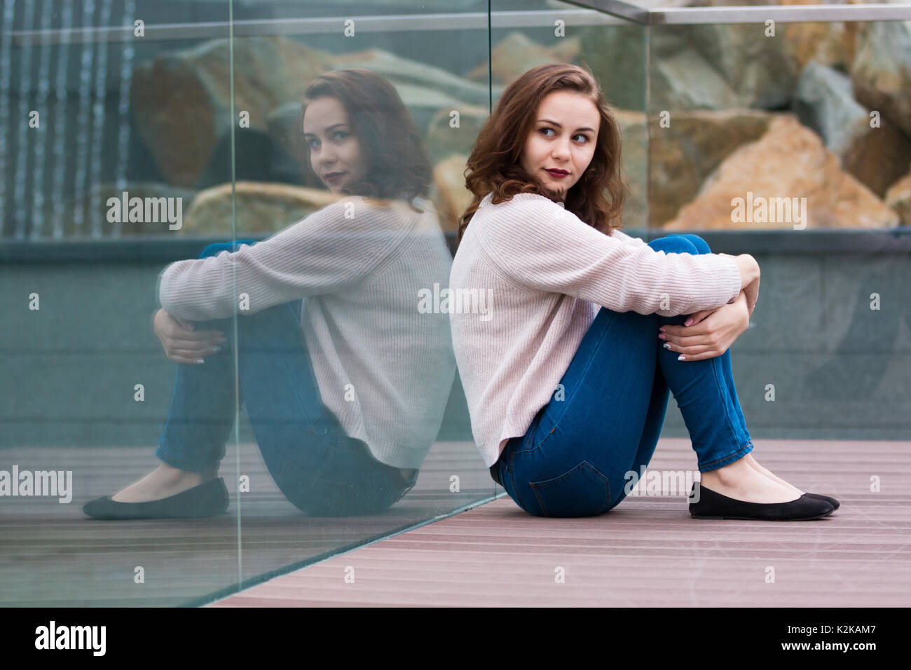 Reflection of cute fashionable girl in modern glass building Stock ...