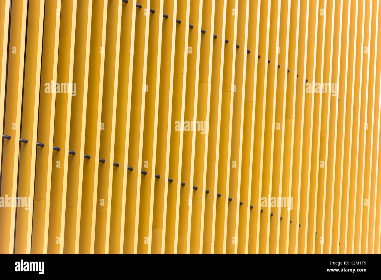 Detail of bright yellow metal building facade. For background Stock ...