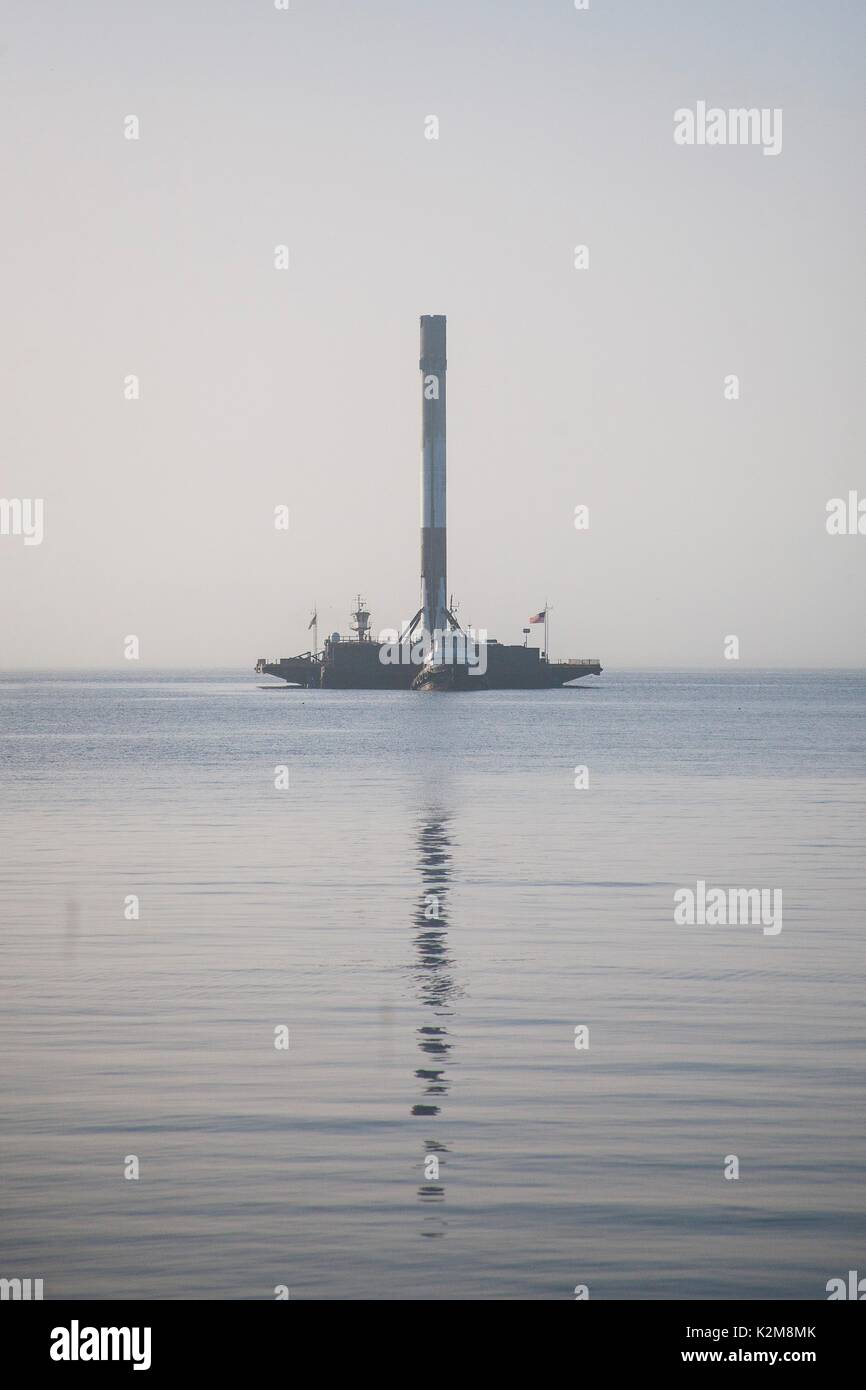 The SpaceX Falcon 9 rocket first stage booster arrives at the Port of ...