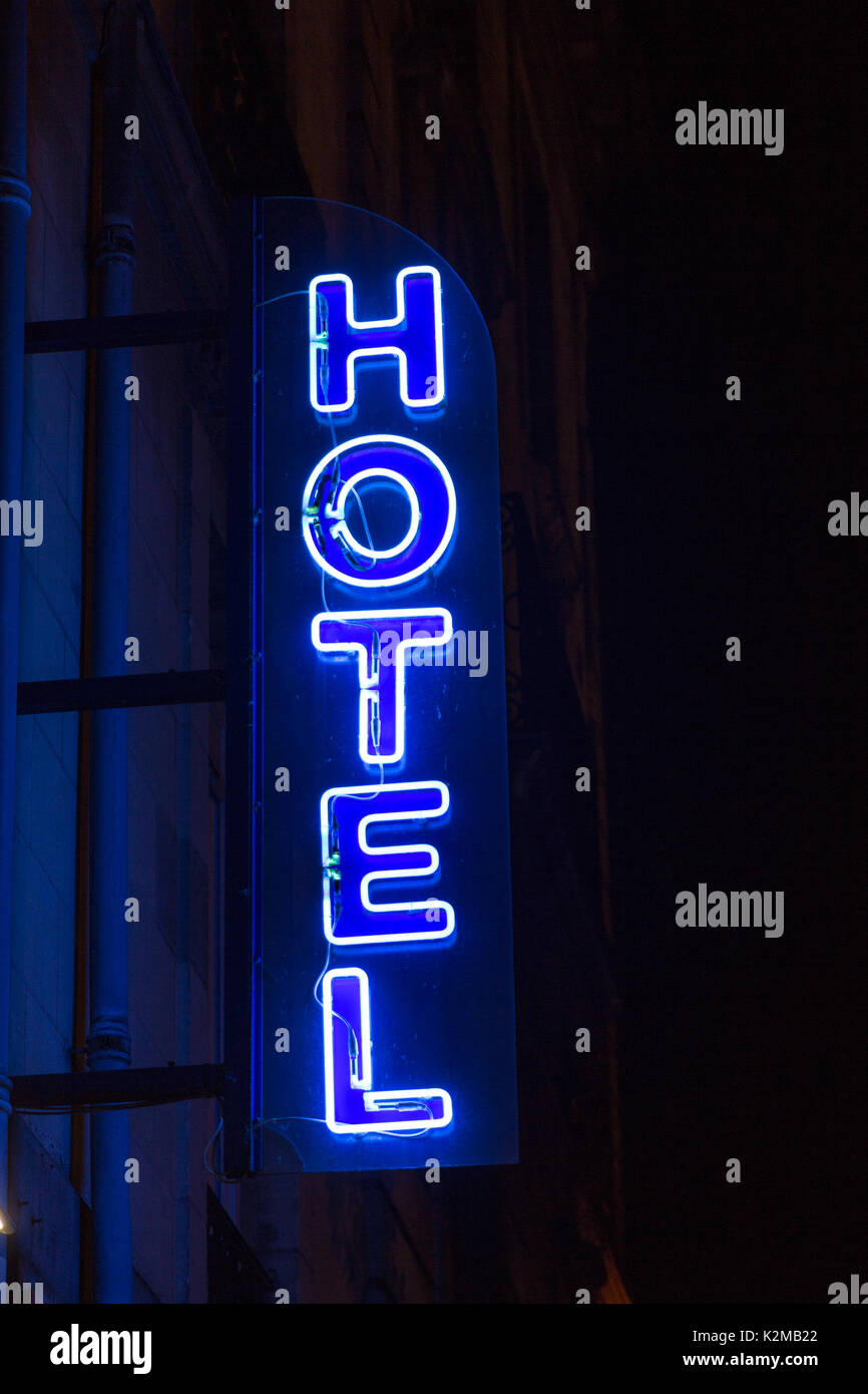Blue neon hotel sign in the night Stock Photo - Alamy
