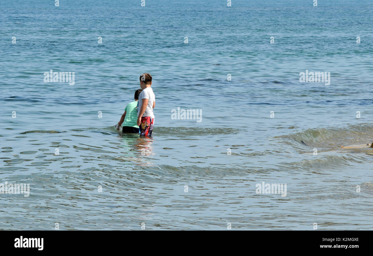 Children splashing in the shallows hi-res stock photography and images ...