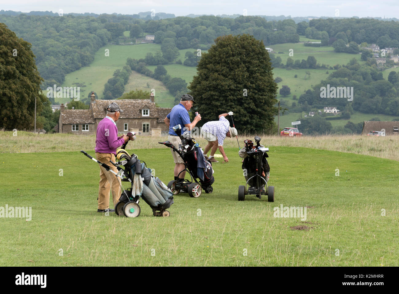 Elderly golfers playing golf in the south Cotswolds region of England ...