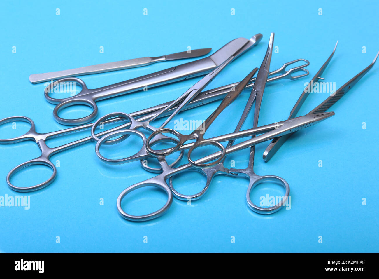 Close Up Surgical instruments and tools on blue mirror background ...