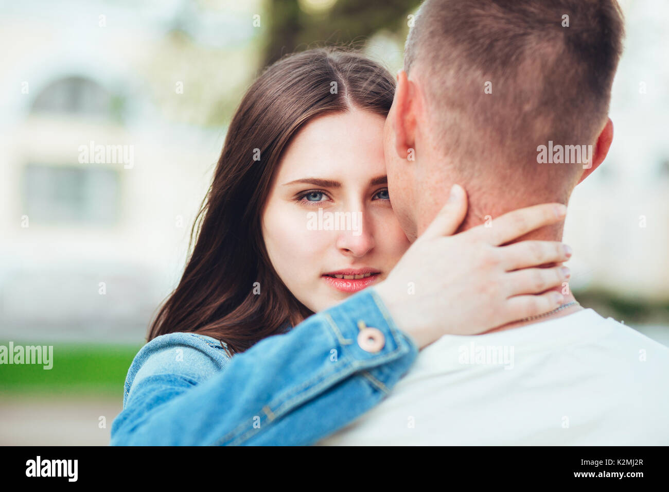 Young couple in love hug each other in city Stock Photo - Alamy