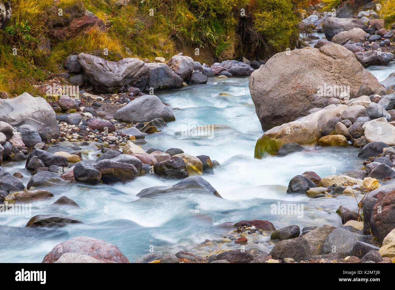 Mountain stream by an autumn surrounded by trees with yellow foliage ...