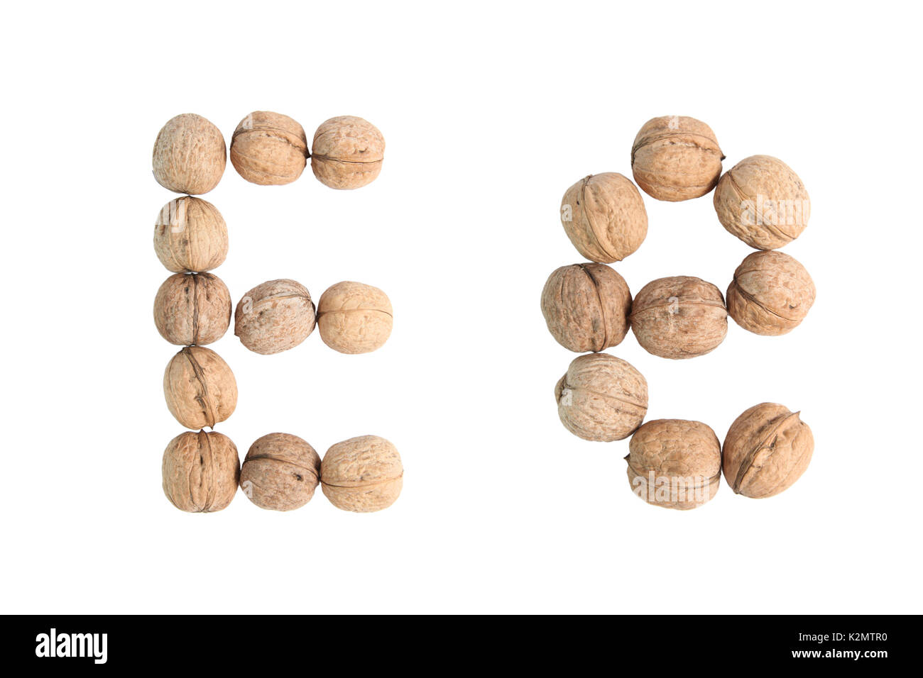 The group of walnuts on white background, making letter E. Studio shot ...