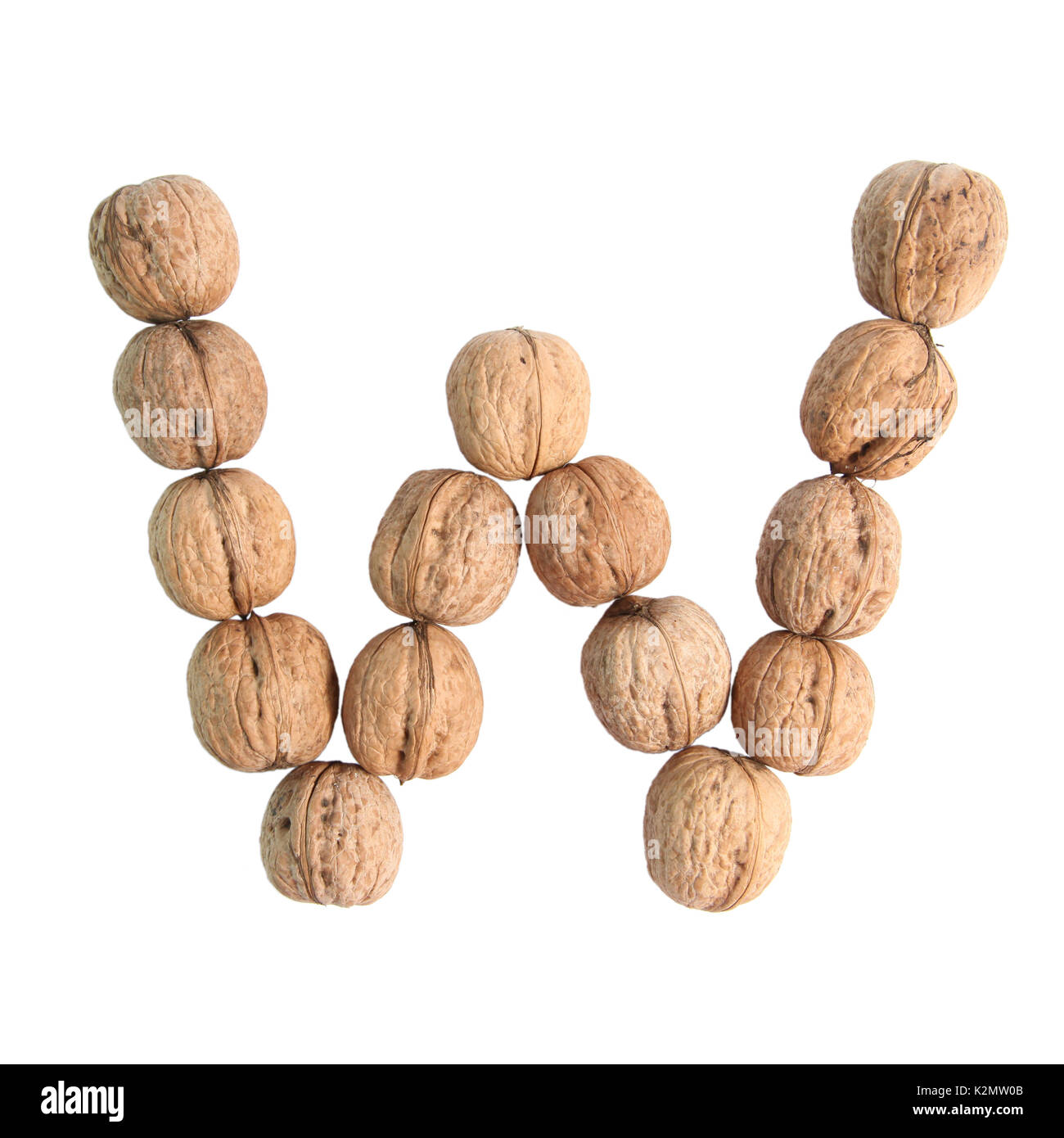 The group of walnuts on white background, making letter W. Studio shot ...