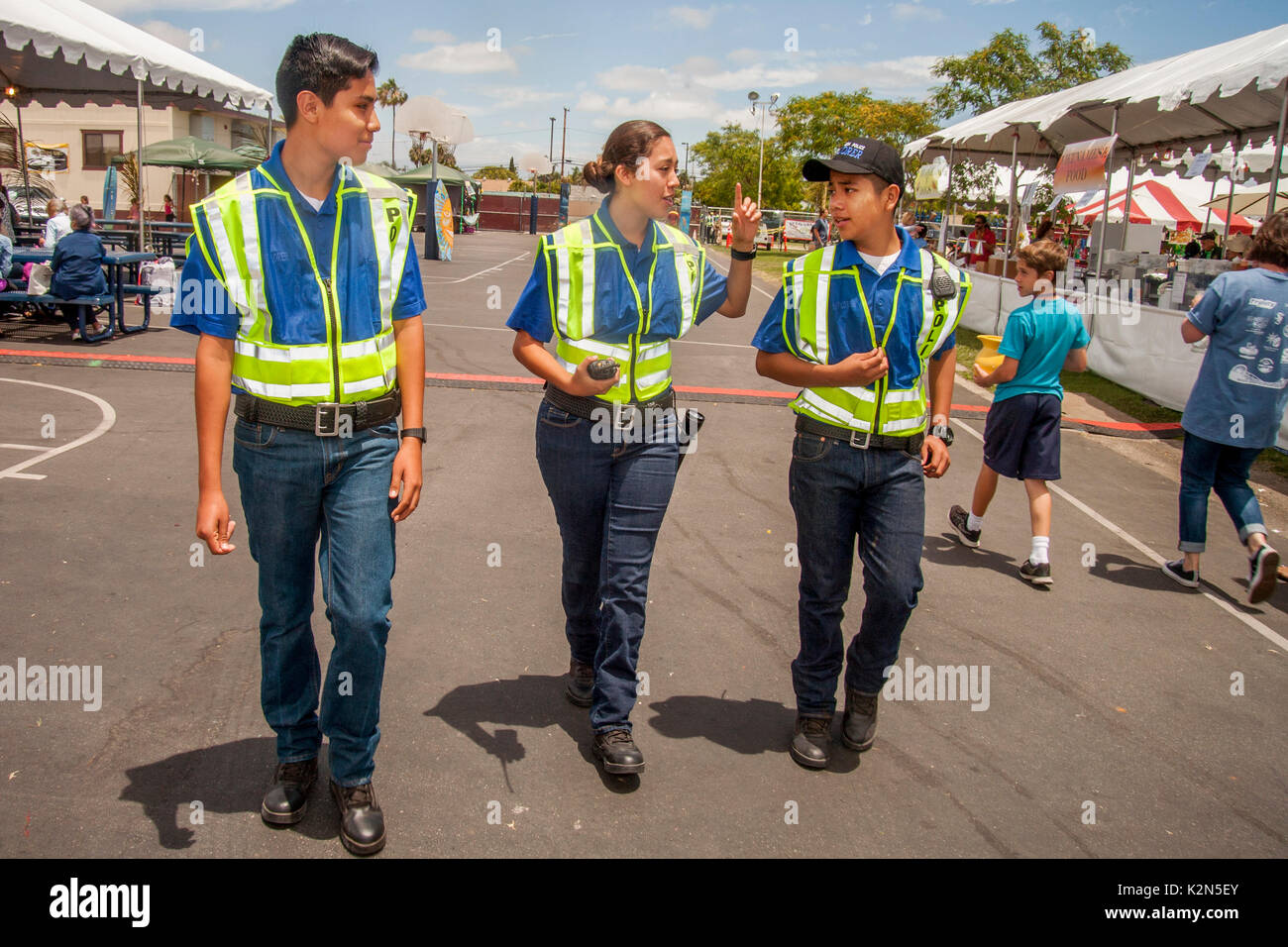Male and female teen Hispanic Explorer Scouts serve as auxiliary police ...