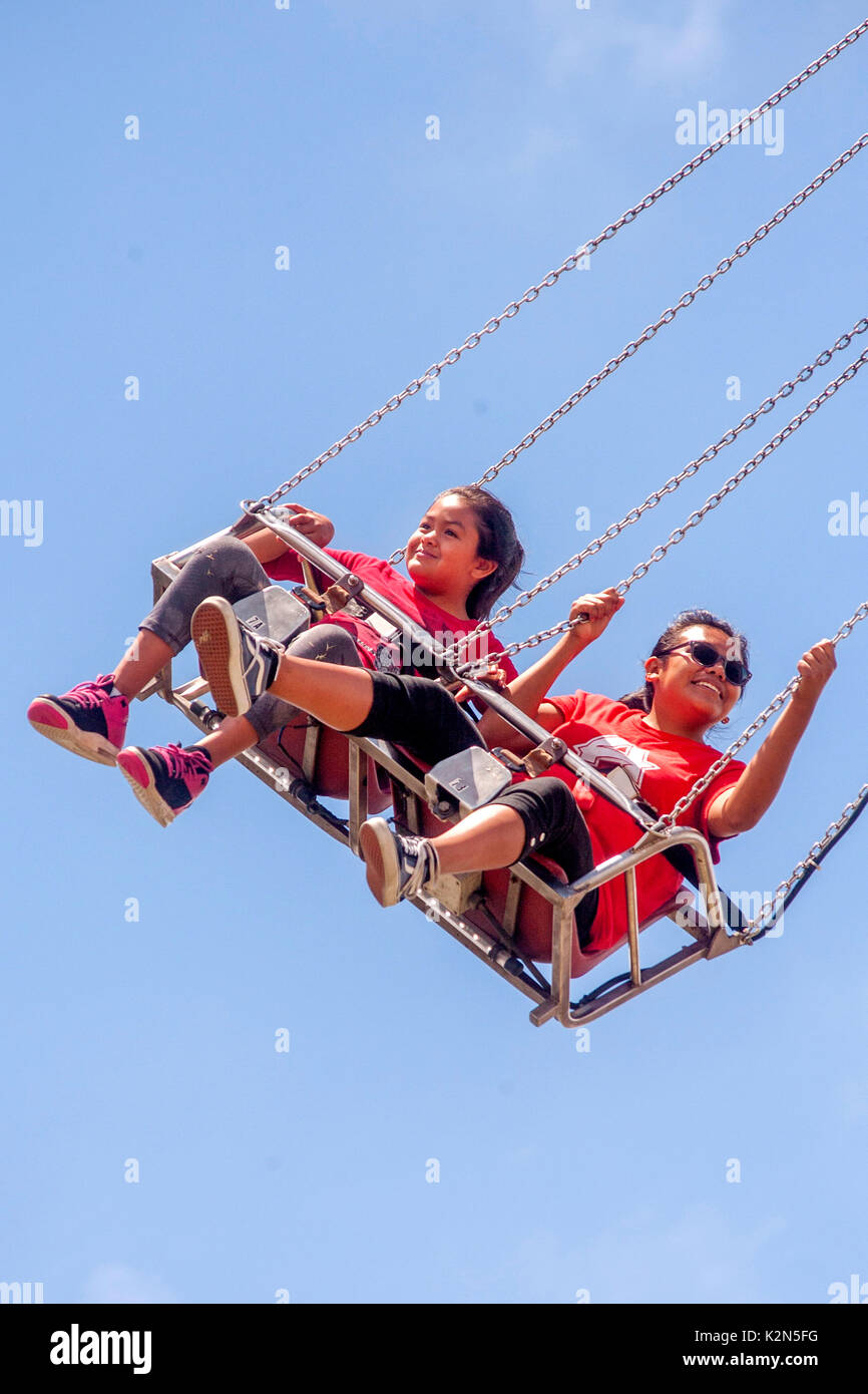 Hispanic teen girls enjoy a "Vertigo" ride at a Costa Mesa, CA ...