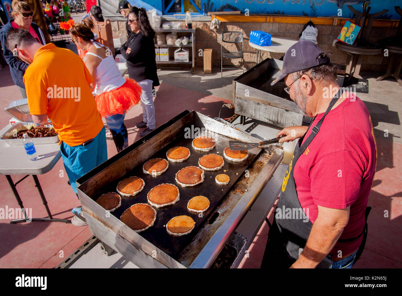 A chef cooks pancakes on an outdoor grill at a festival in Huntington ...