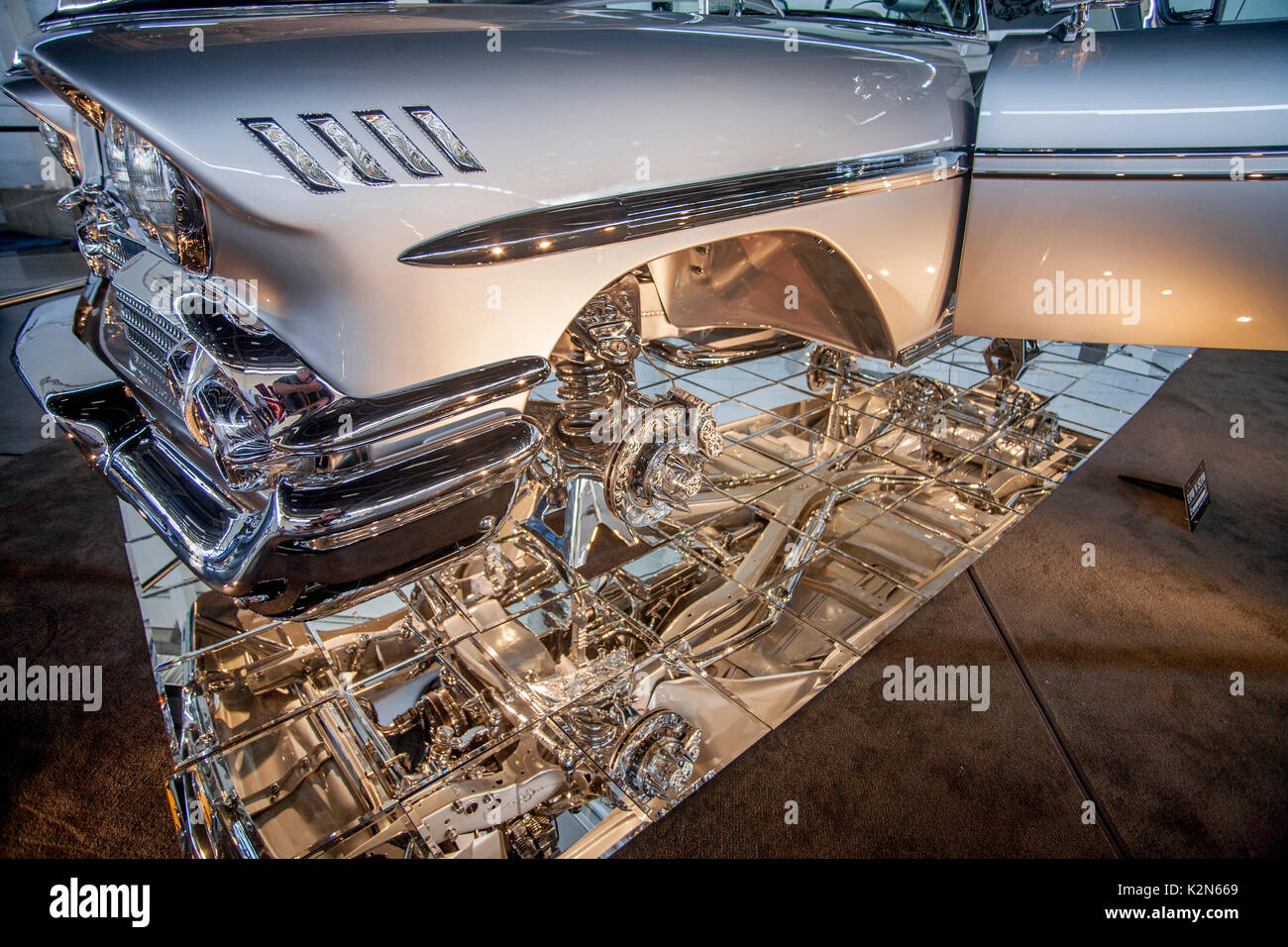 The chromium underside of a heavily customized 1958 Chevrolet Impala is ...