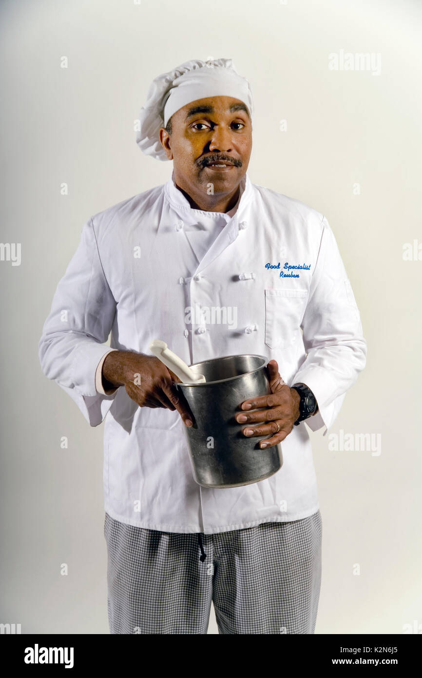 An African American railroad chef holds a mixing on a train in the Los ...