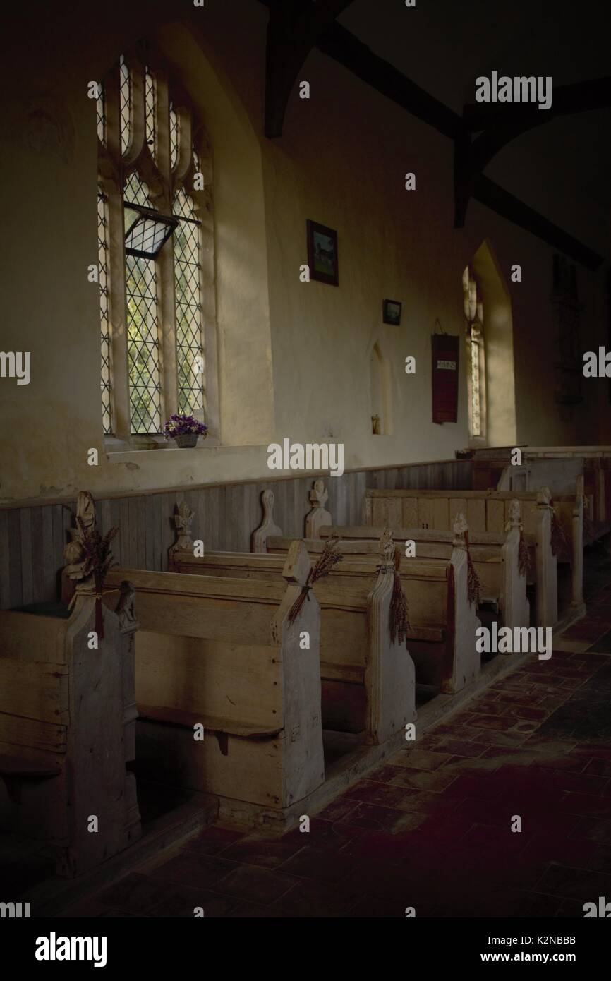 Gloomy english church interior with wooden pews Stock Photo - Alamy