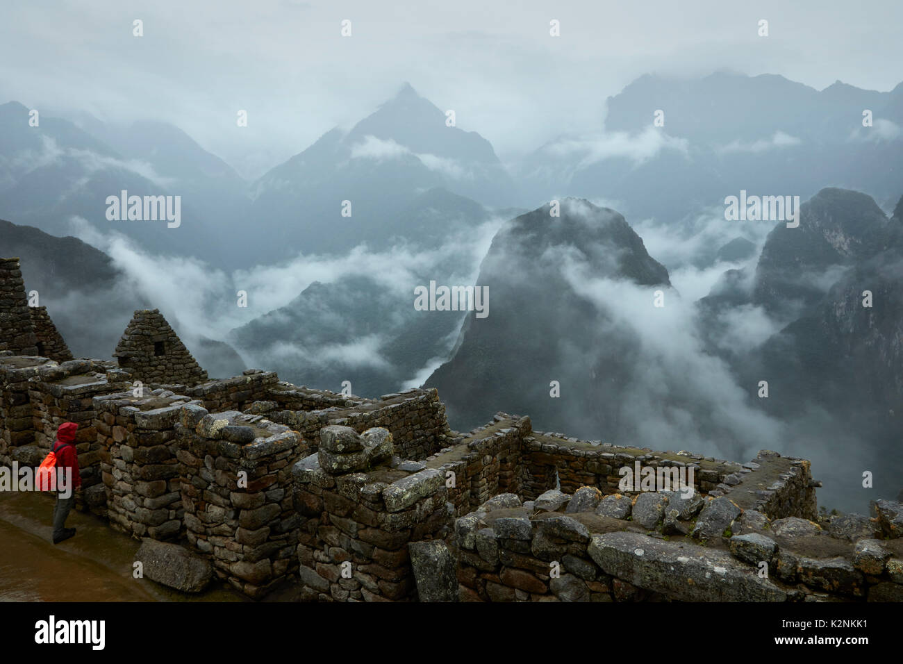 Stone houses, tourist and misty mountains, Machu Picchu (World Heritage ...