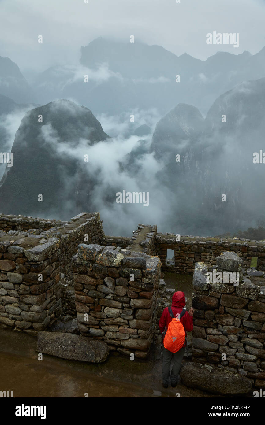 Stone houses, tourist and misty mountains, Machu Picchu (World Heritage ...