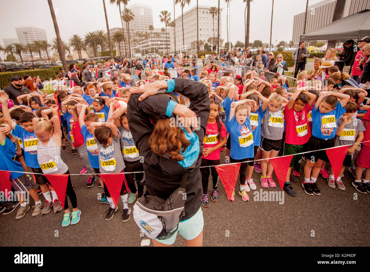 An enthusiastic multiracial group of children gather at the starting ...