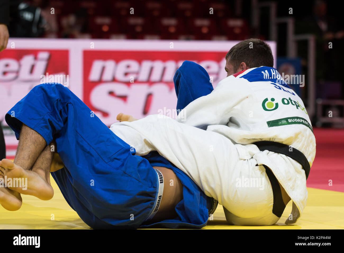 Martin Hojak of Slovenia (white kimono) and Axus Benjamin of France ...