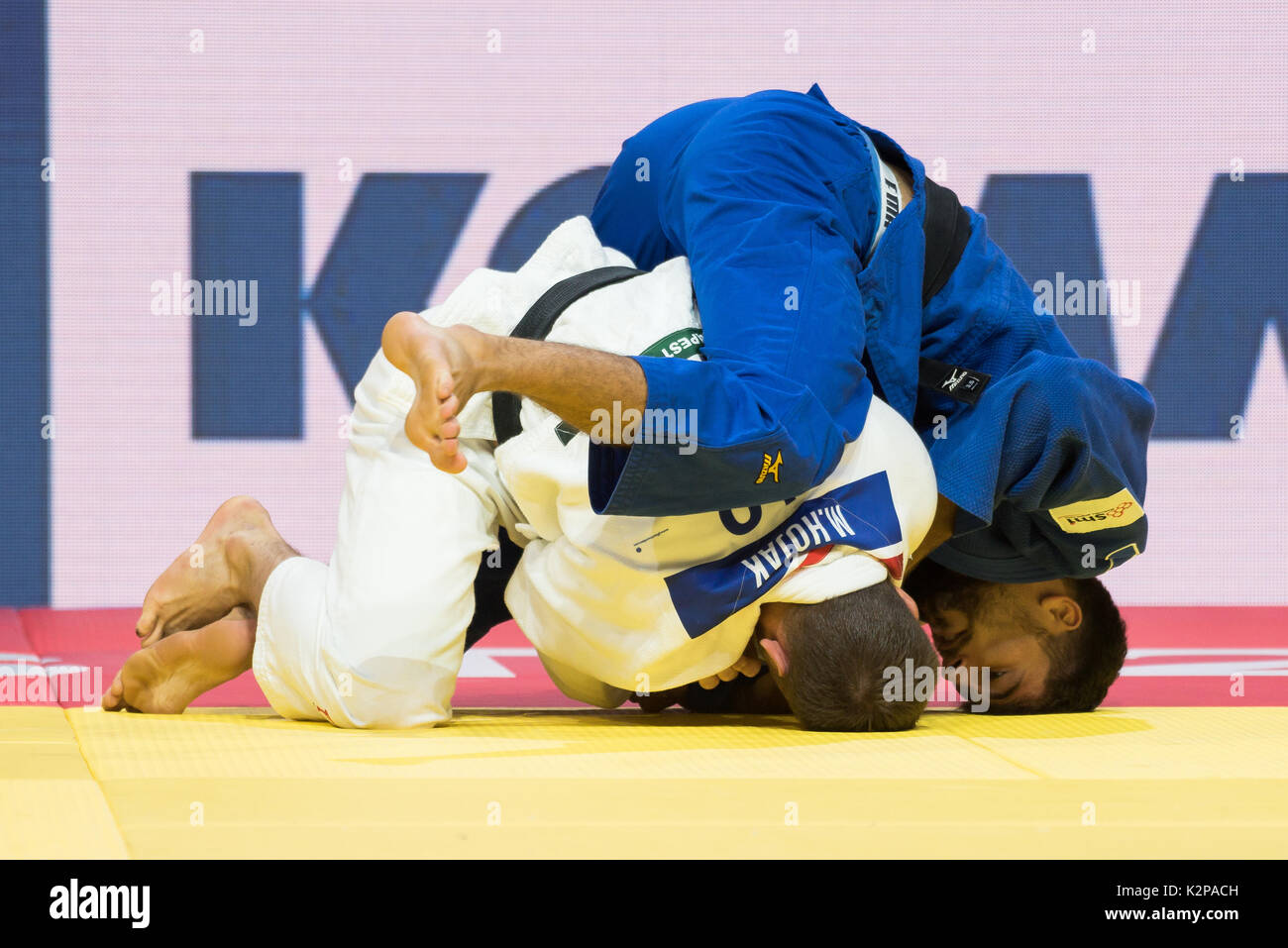 Martin Hojak of Slovenia (white kimono) and Axus Benjamin of France ...