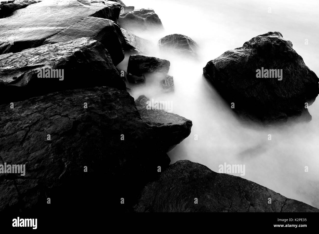 Black and white long exposure water and stones background in cool ...