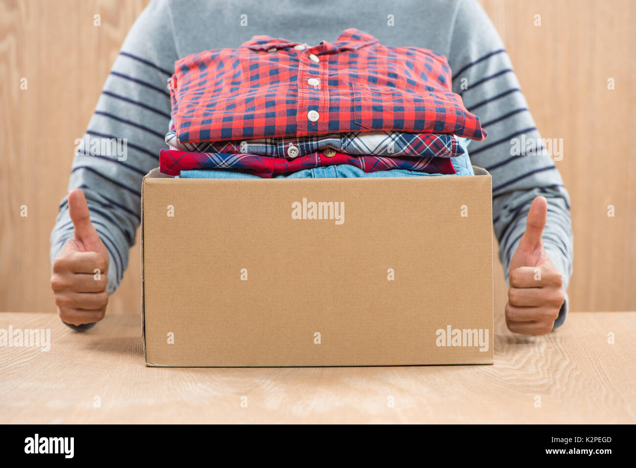 Donation box for poor with clothing in male hands Stock Photo - Alamy
