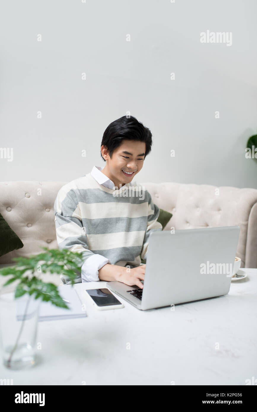 Asian young business man working with laptop atthe city cafe Stock ...