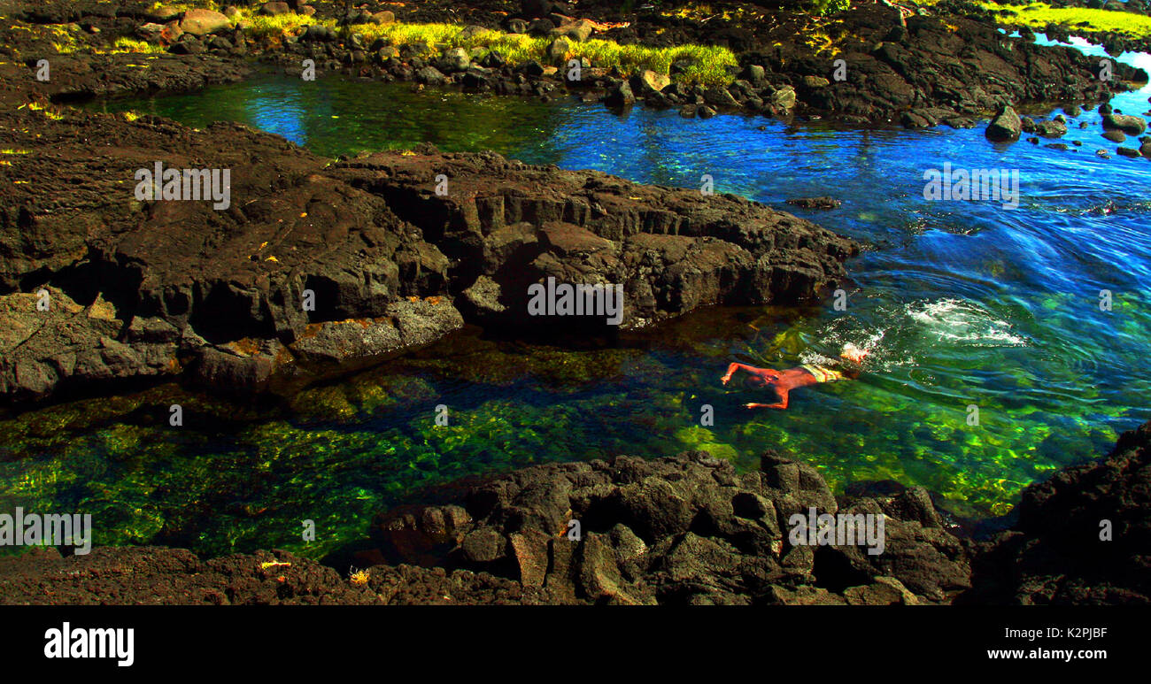 Big Island, Hawaii, USA. 17th July, 2010. A swimmer navigated a lava ...