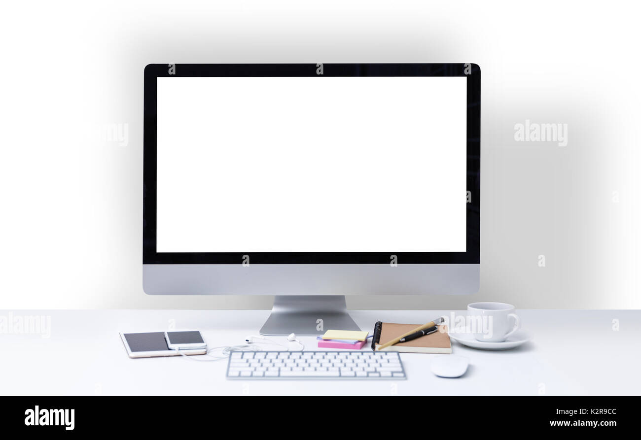 Office desk with computer screen, keyboard, mouse, stationary and ...