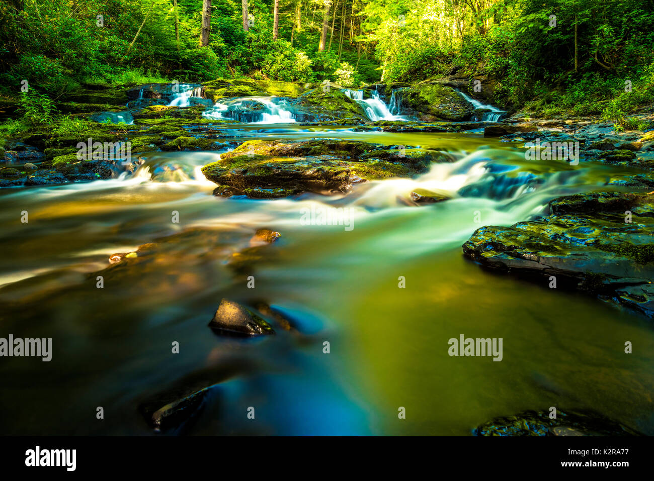 Hidden forest waterfall long exposure background Stock Photo - Alamy