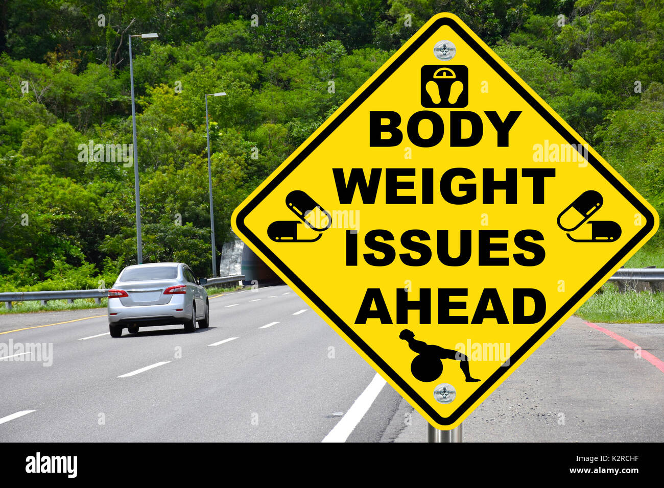 Body wight issues ahead yellow warning sign Stock Photo - Alamy