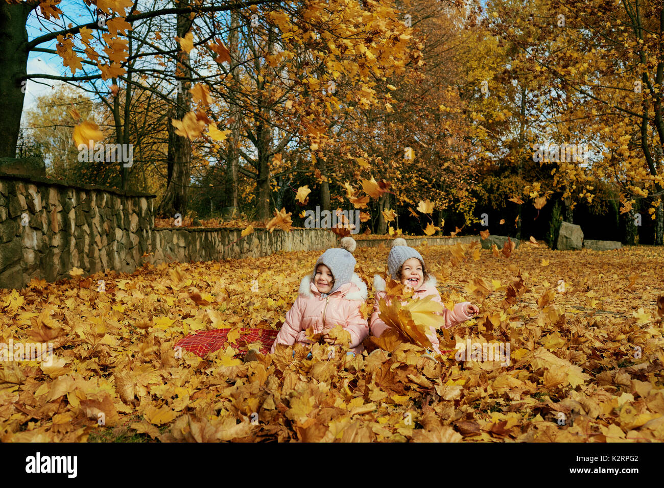 Two happy children in autumn clothes in the park Stock Photo - Alamy