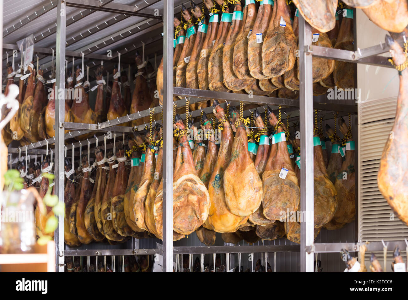 Dry and salty joints of spanish jamon hanging in bodega Stock Photo - Alamy