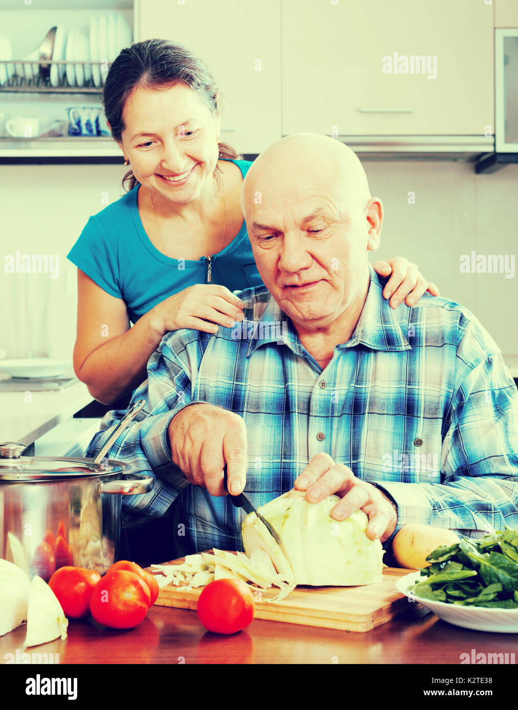 mature couple cooking food together in kitchen Stock Photo - Alamy