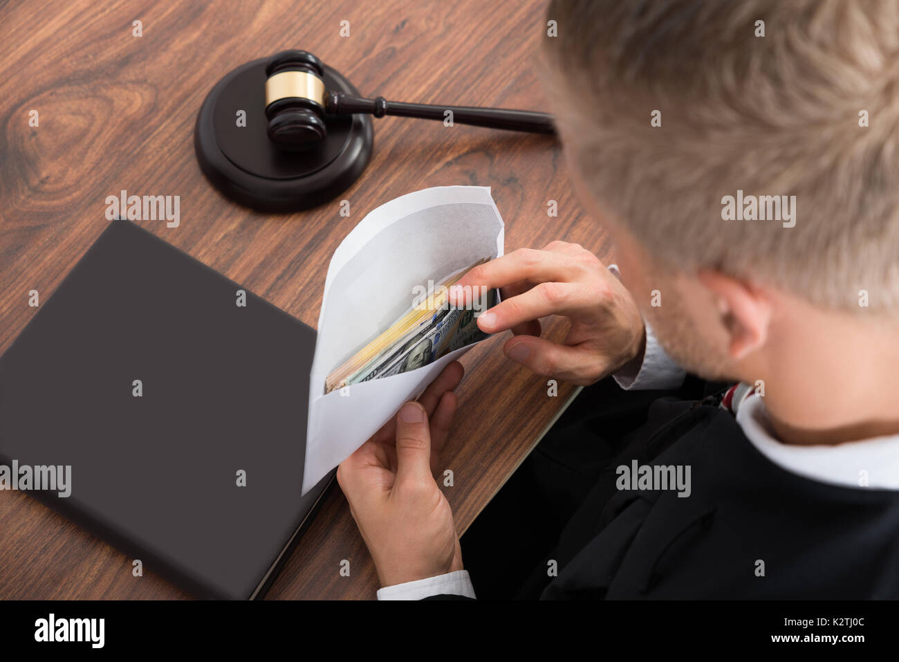 Close-up Of Judge Looking At Money At Desk In Courtroom Stock Photo - Alamy
